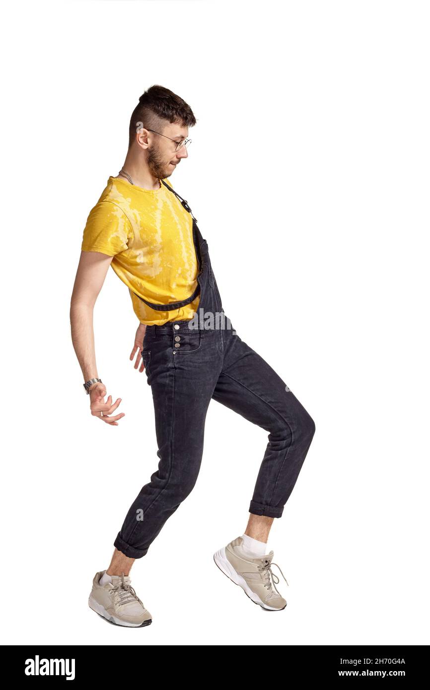 Full-length portrait of a funny guy dancing in studio isolated on white ...