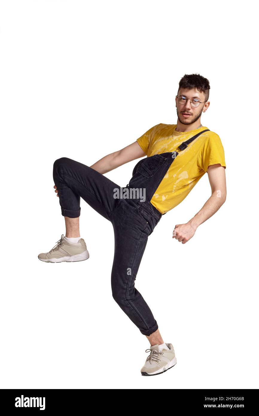 Full-length portrait of a funny guy dancing in studio isolated on white ...