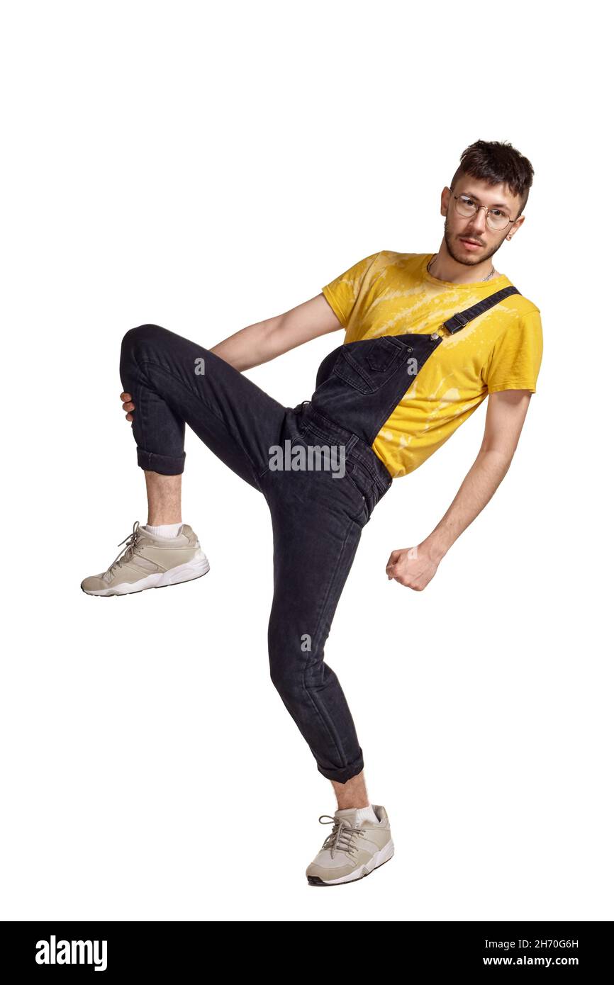 Full-length portrait of a funny guy dancing in studio isolated on white ...