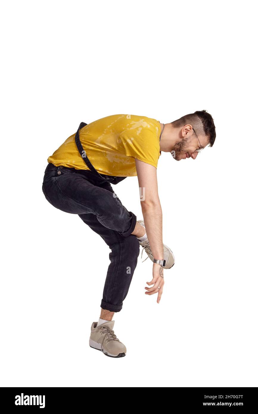 Full-length portrait of a funny guy dancing in studio isolated on white ...