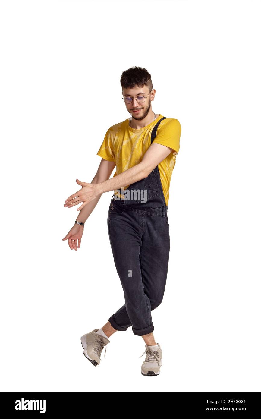 Full-length portrait of a funny guy dancing in studio isolated on white ...