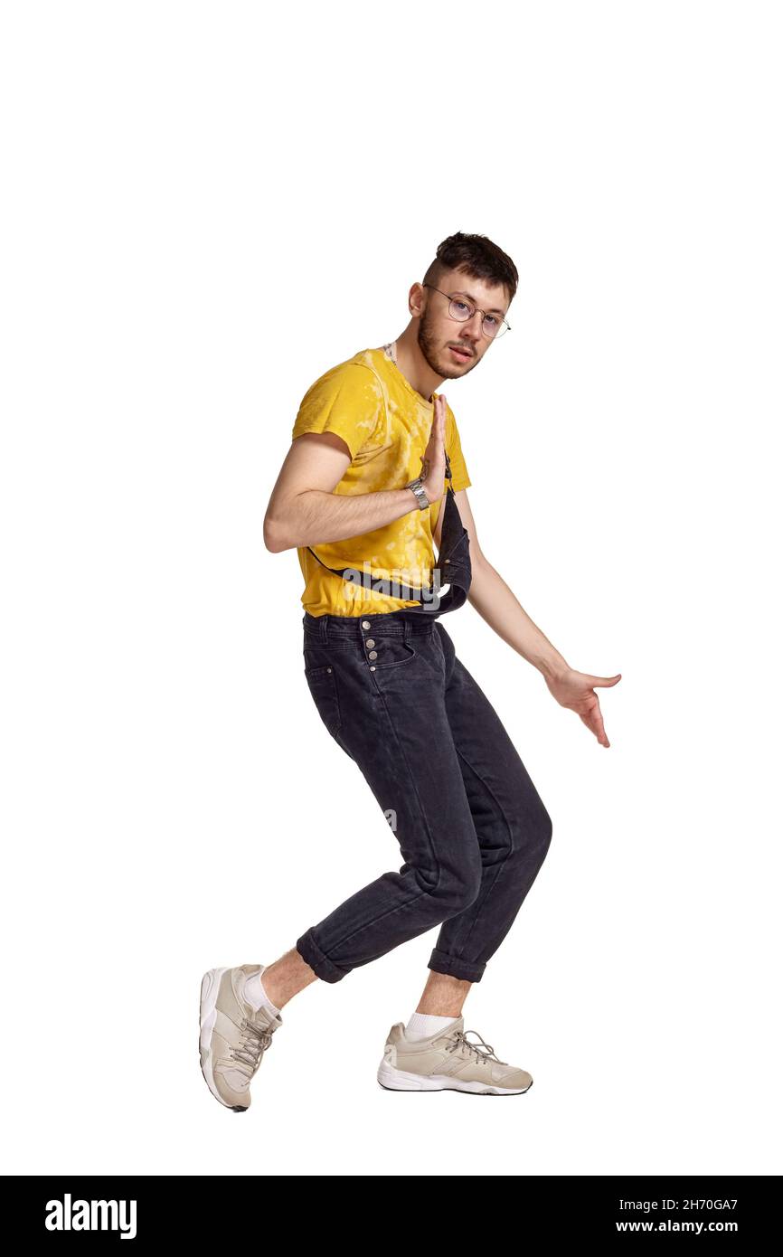 Full-length portrait of a funny guy dancing in studio isolated on white ...