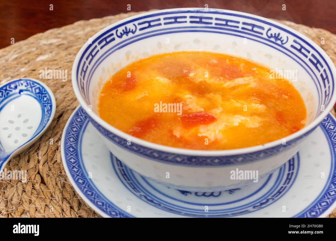 Bowl of traditional chinese tomato soup with fresh tomatoes and egg ...
