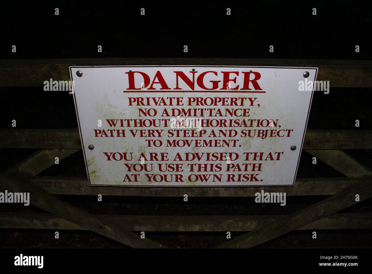 Danger use path at your own risk sign. Rousdon cliffs. The England ...