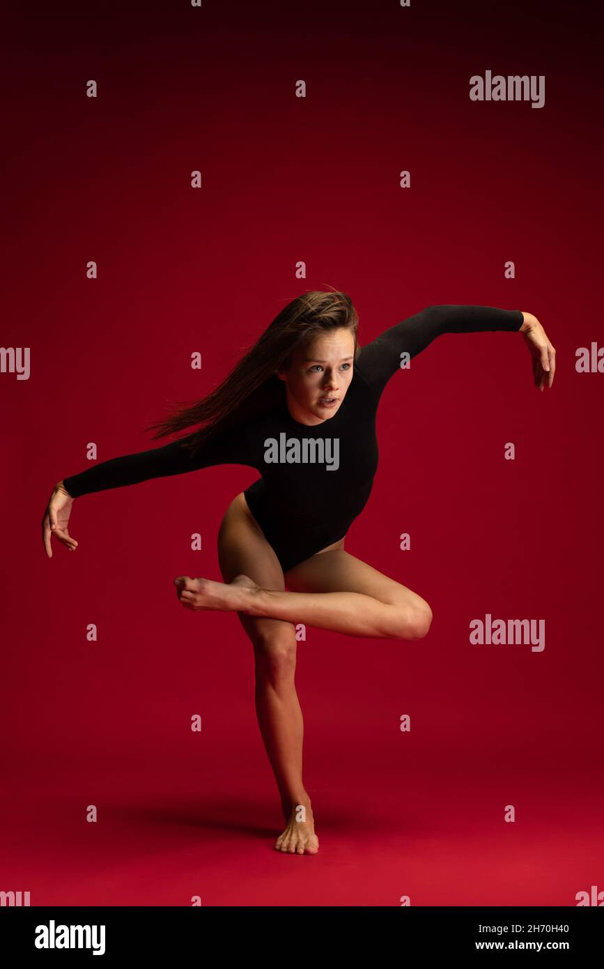One emotional young flexible contemp dancer, ballerina jumping isolated ...