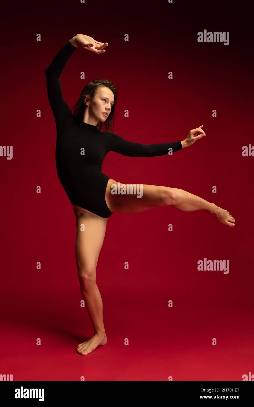 One emotional young flexible contemp dancer, ballerina jumping isolated ...