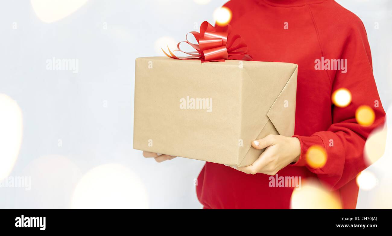Christmas Gifts in woman's hands. Express delivery. A young woman in a ...