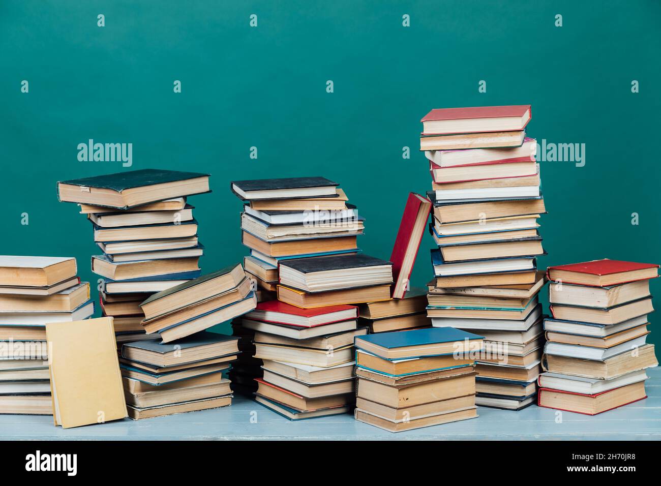 stacks of books in the university library on a green background Stock ...