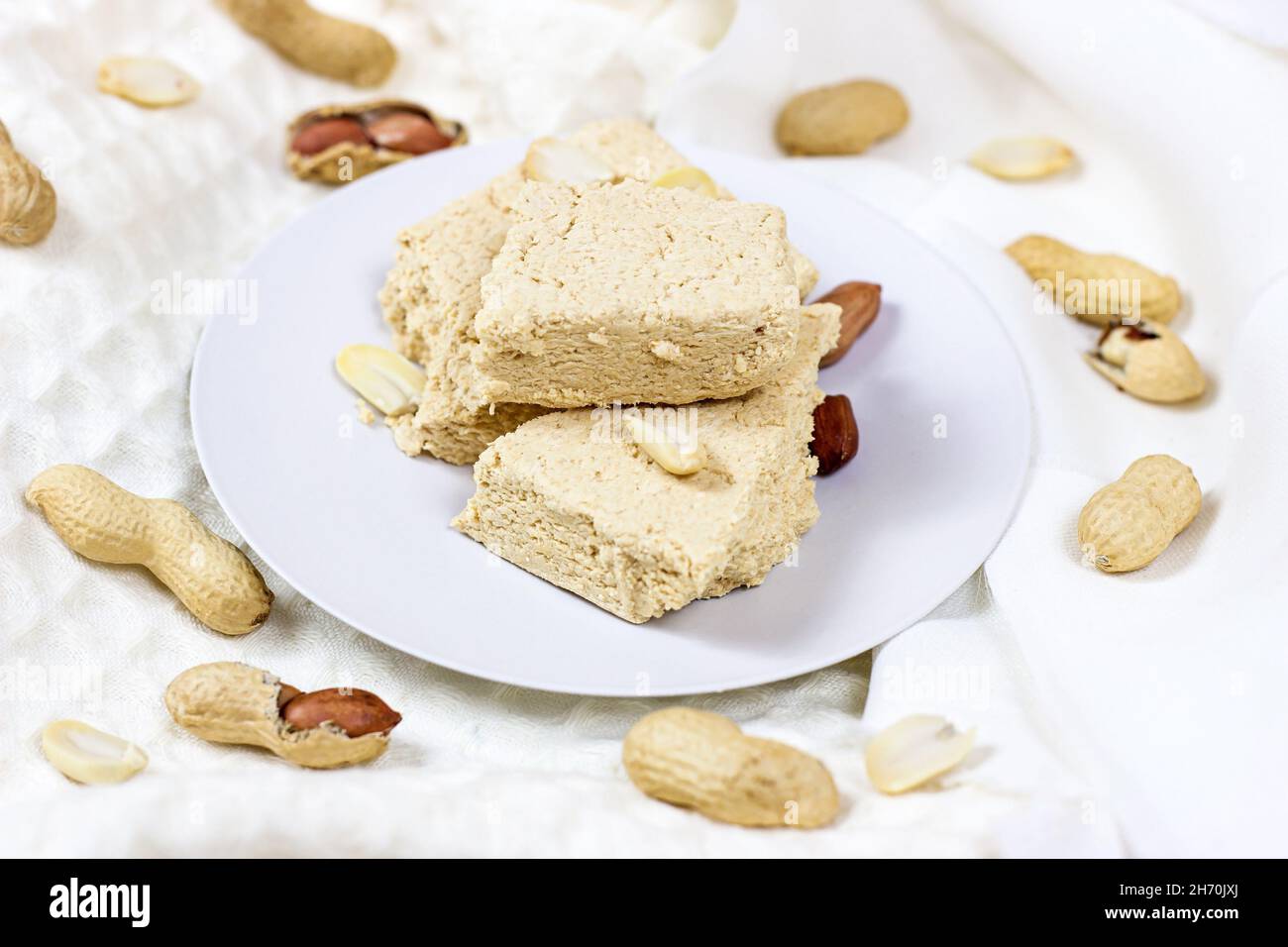 Traditional sweet turkish delight halva pieces with peanut nuts on ...