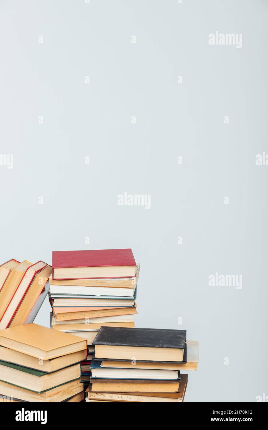 stacks of educational books in the college library on a white ...