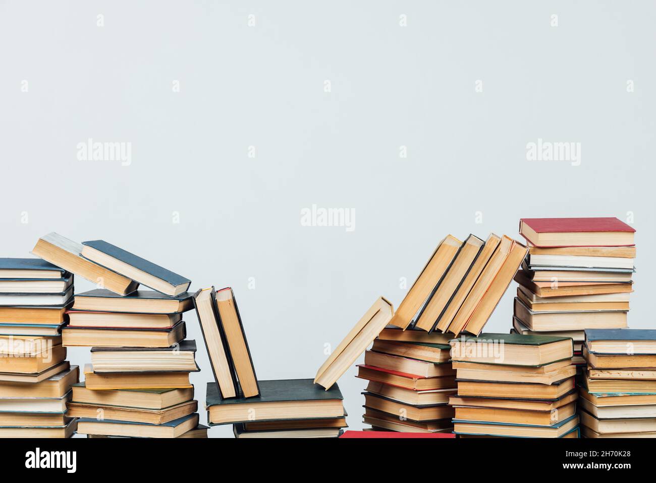 stacks of educational books in the college library on a white ...