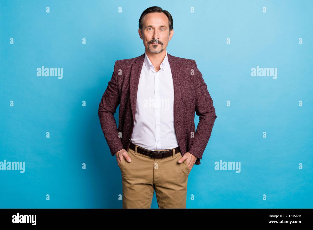 Photo of concentrated successful ceo bearded man hands pockets wear red ...