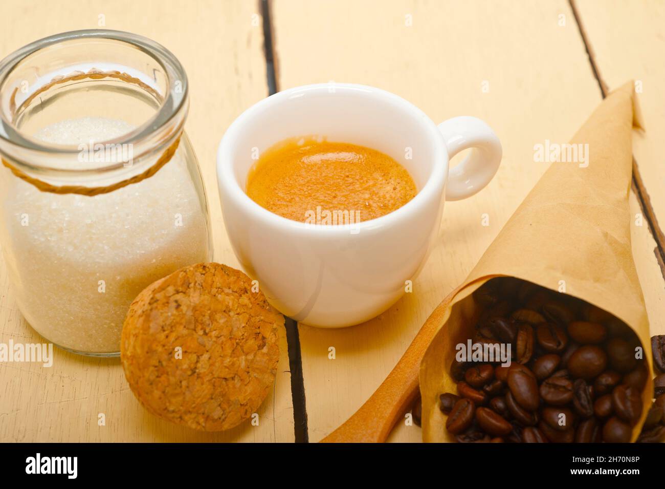 espresso coffee and beans on a paper cone cornucopia over white ...