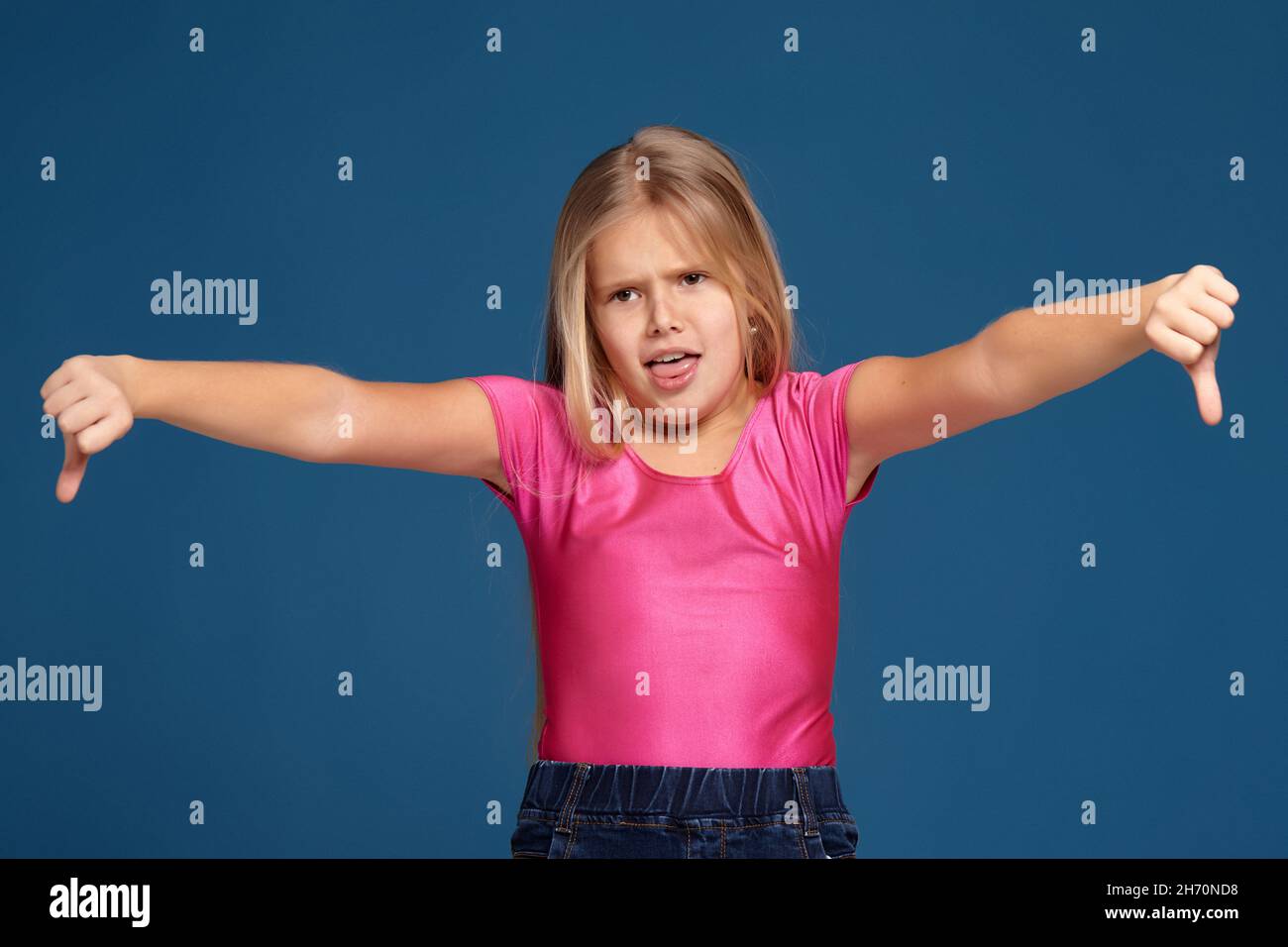 Portrait of emotional expressive little girl on blue background Stock ...