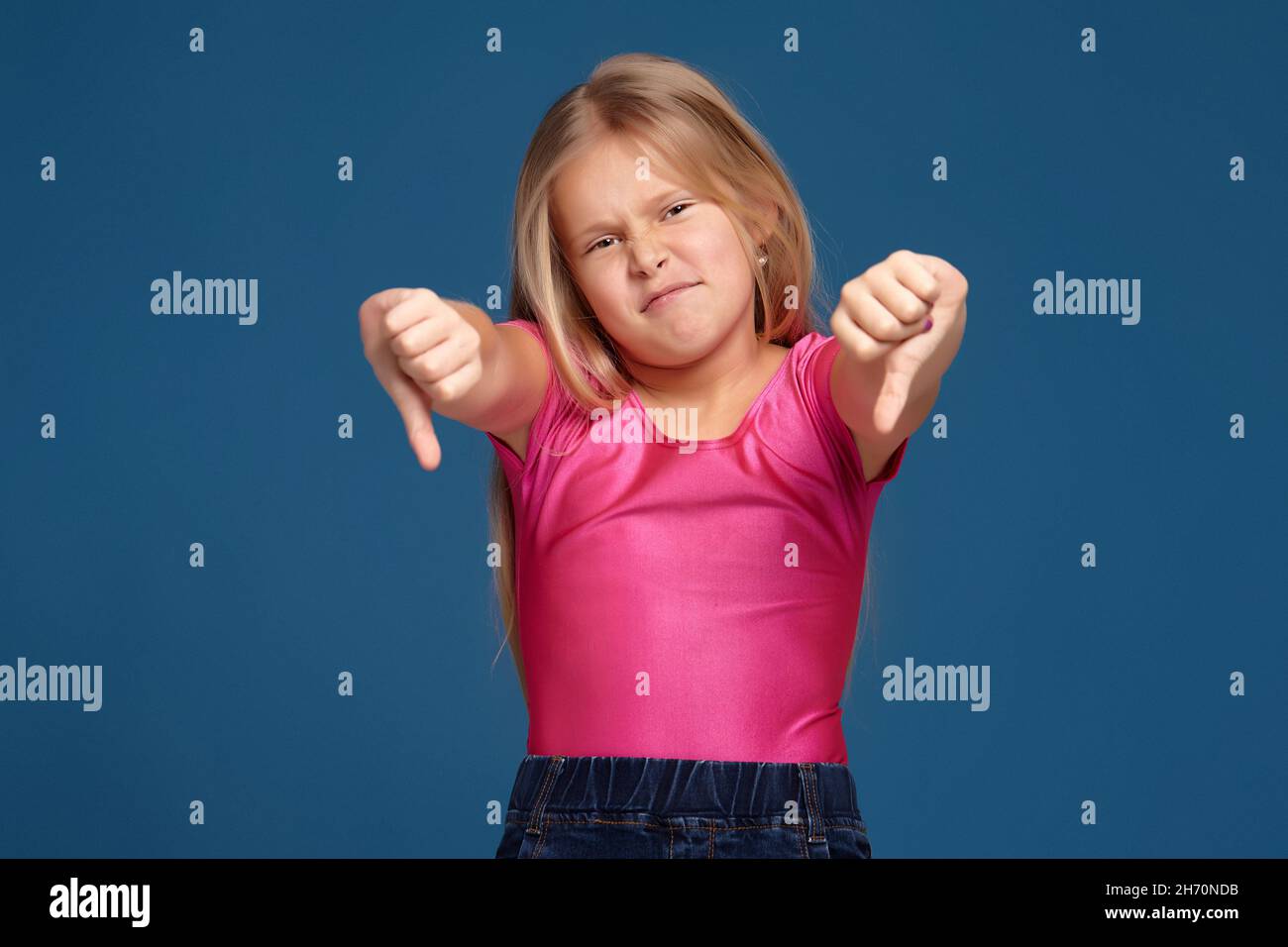 Portrait of emotional expressive little girl on blue background Stock ...