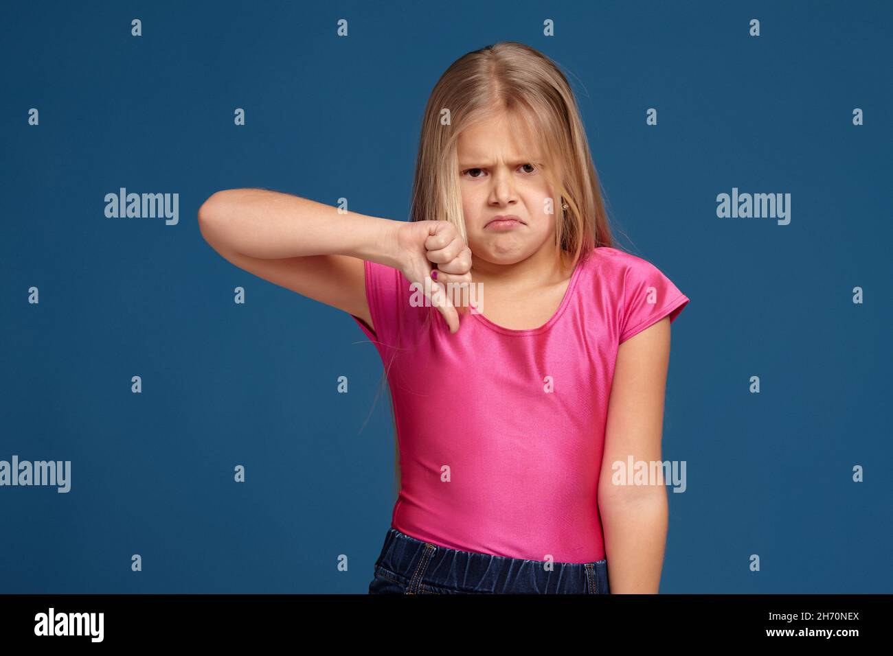 Portrait of emotional expressive little girl on blue background Stock ...