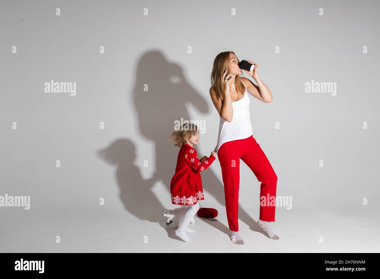 Cute kid asking distracted young lady to play with her Stock Photo - Alamy