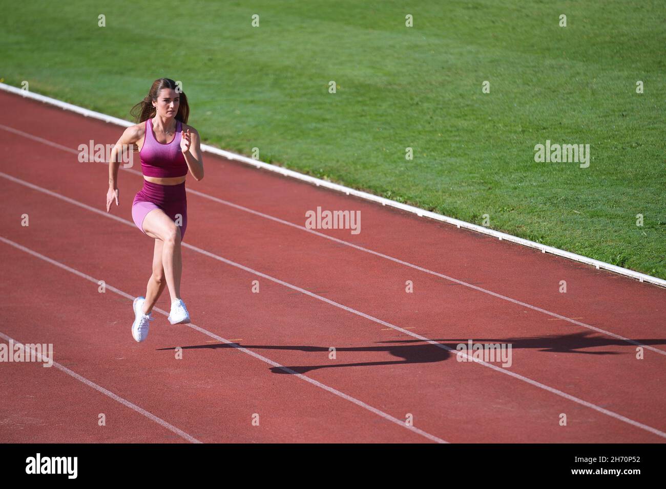 Girl model athlete running on the running track Stock Photo - Alamy
