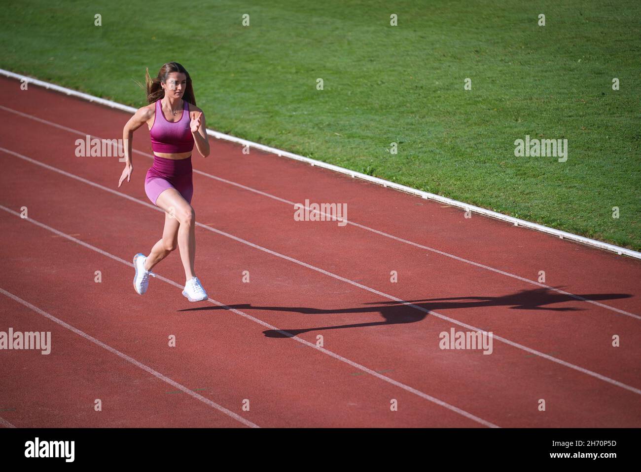 Girl model athlete running on the running track Stock Photo - Alamy