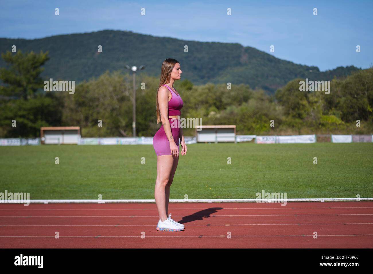 Girl model athlete running on the running track Stock Photo - Alamy