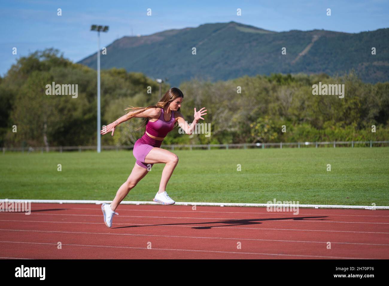 Girl model athlete running on the running track Stock Photo - Alamy