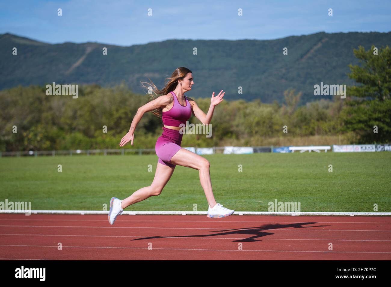 Girl model athlete running on the running track Stock Photo - Alamy