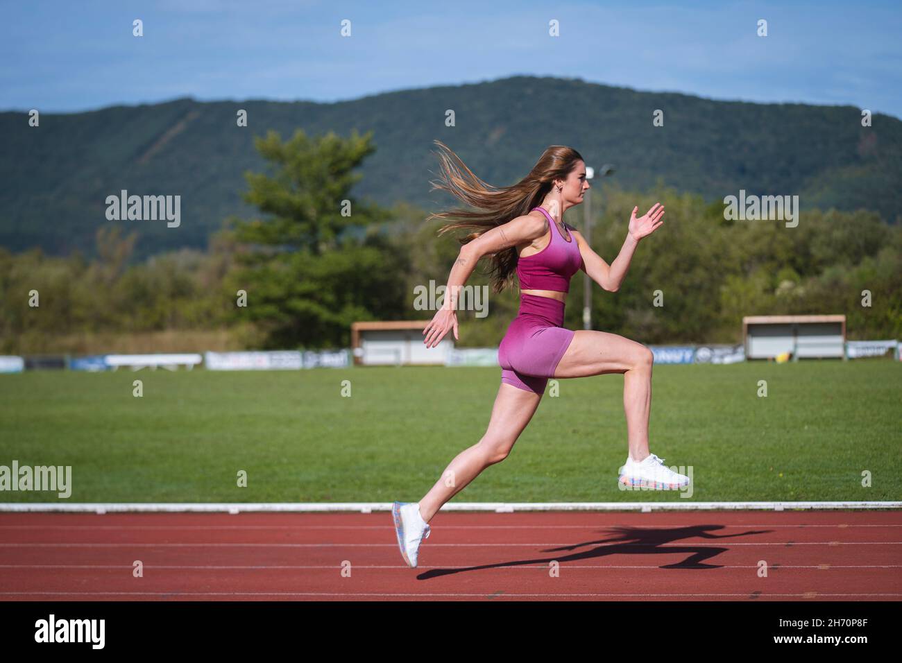 Girl model athlete running on the running track Stock Photo - Alamy