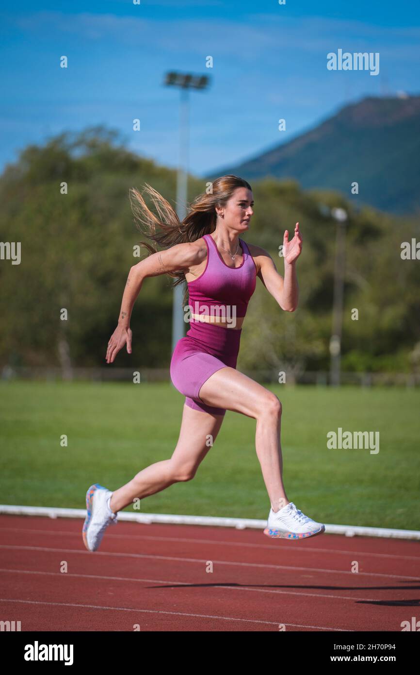 Girl model athlete running on the running track Stock Photo - Alamy