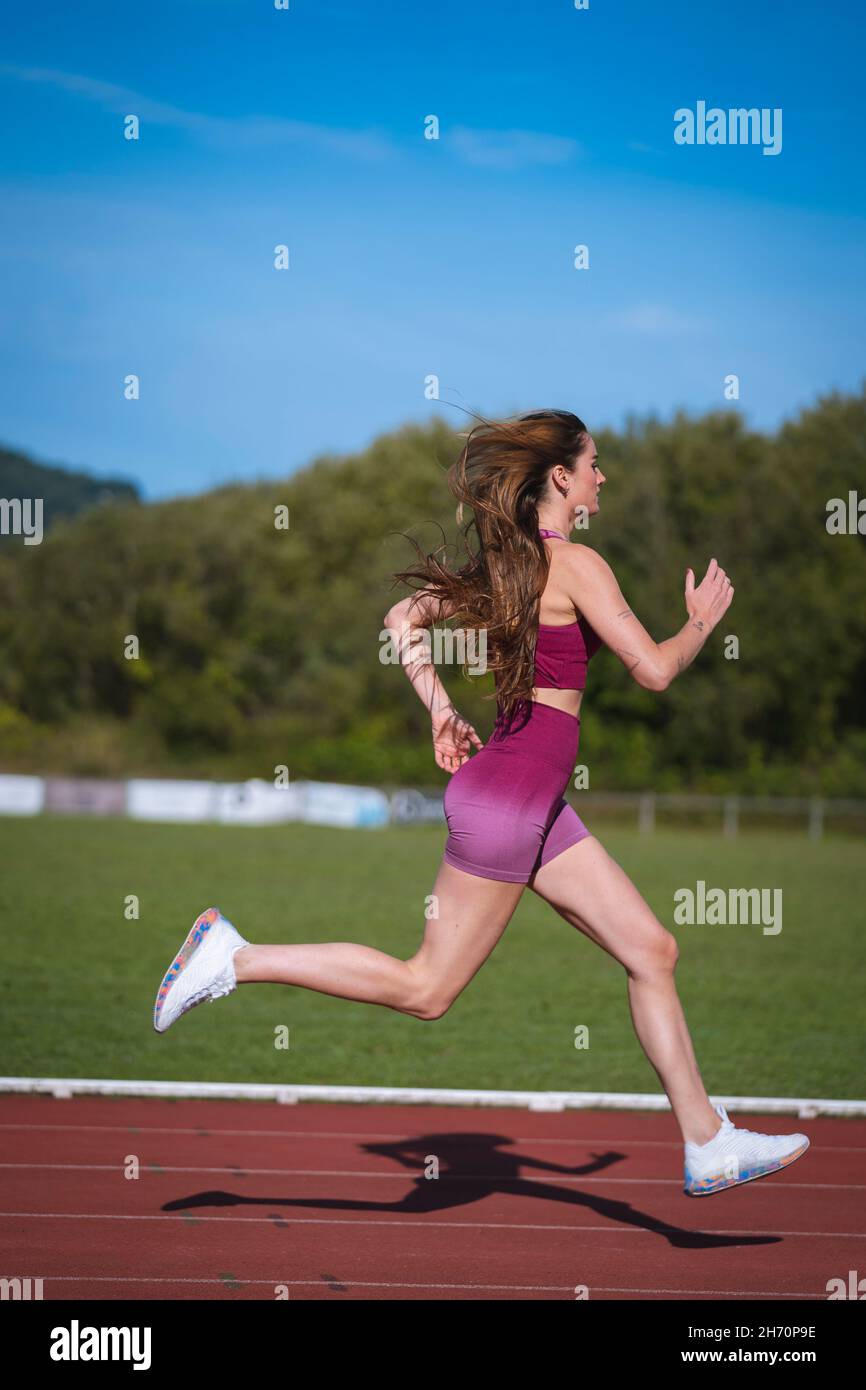 Girl model athlete running on the running track Stock Photo - Alamy