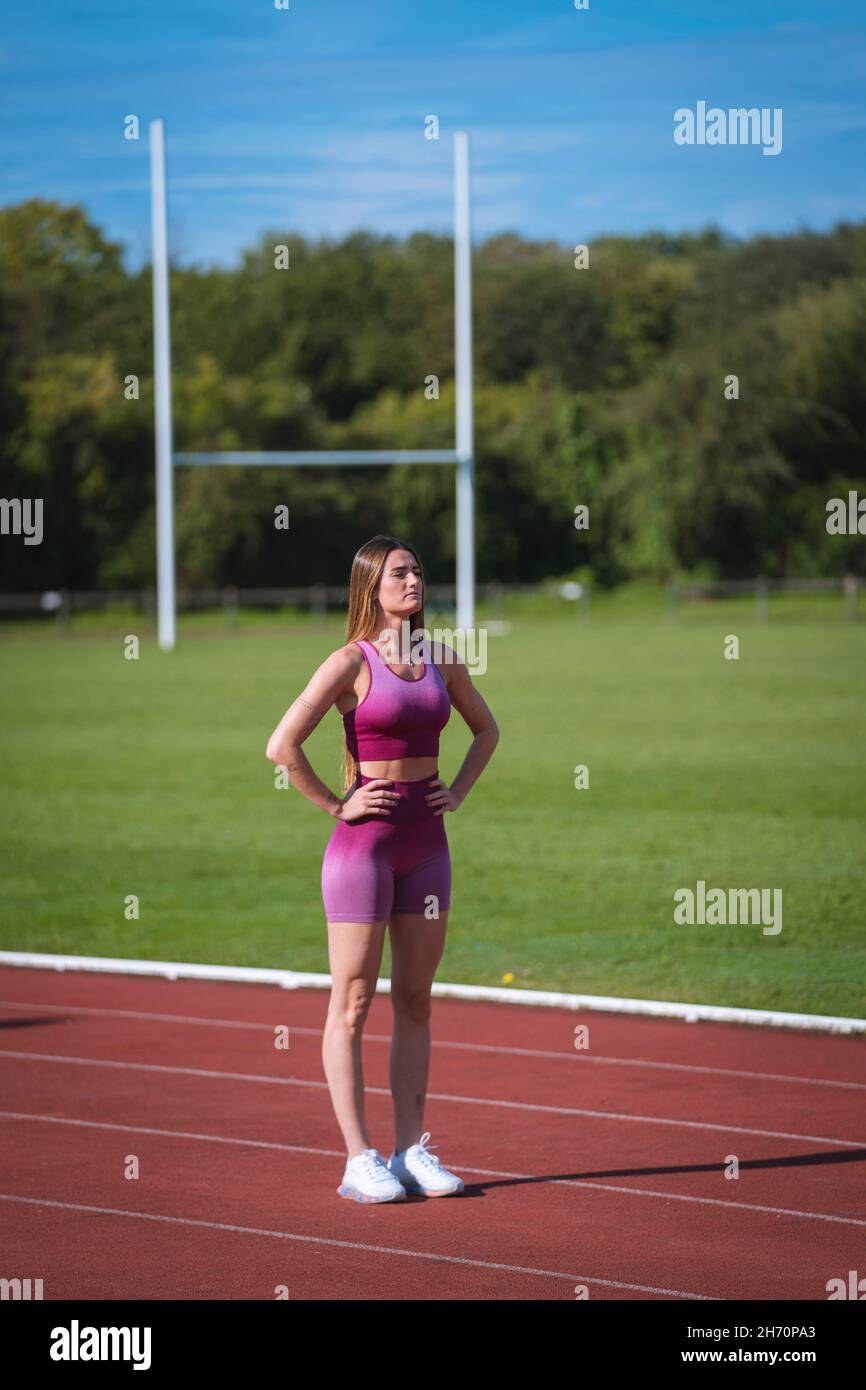 Athlete model girl posing on the running track Stock Photo - Alamy