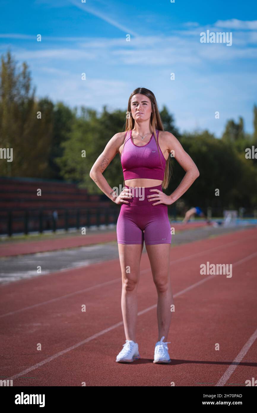 Athlete model girl posing on the running track Stock Photo - Alamy