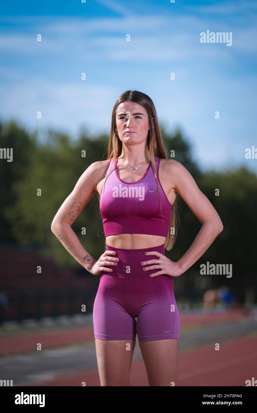 Athlete model girl posing on the running track Stock Photo - Alamy