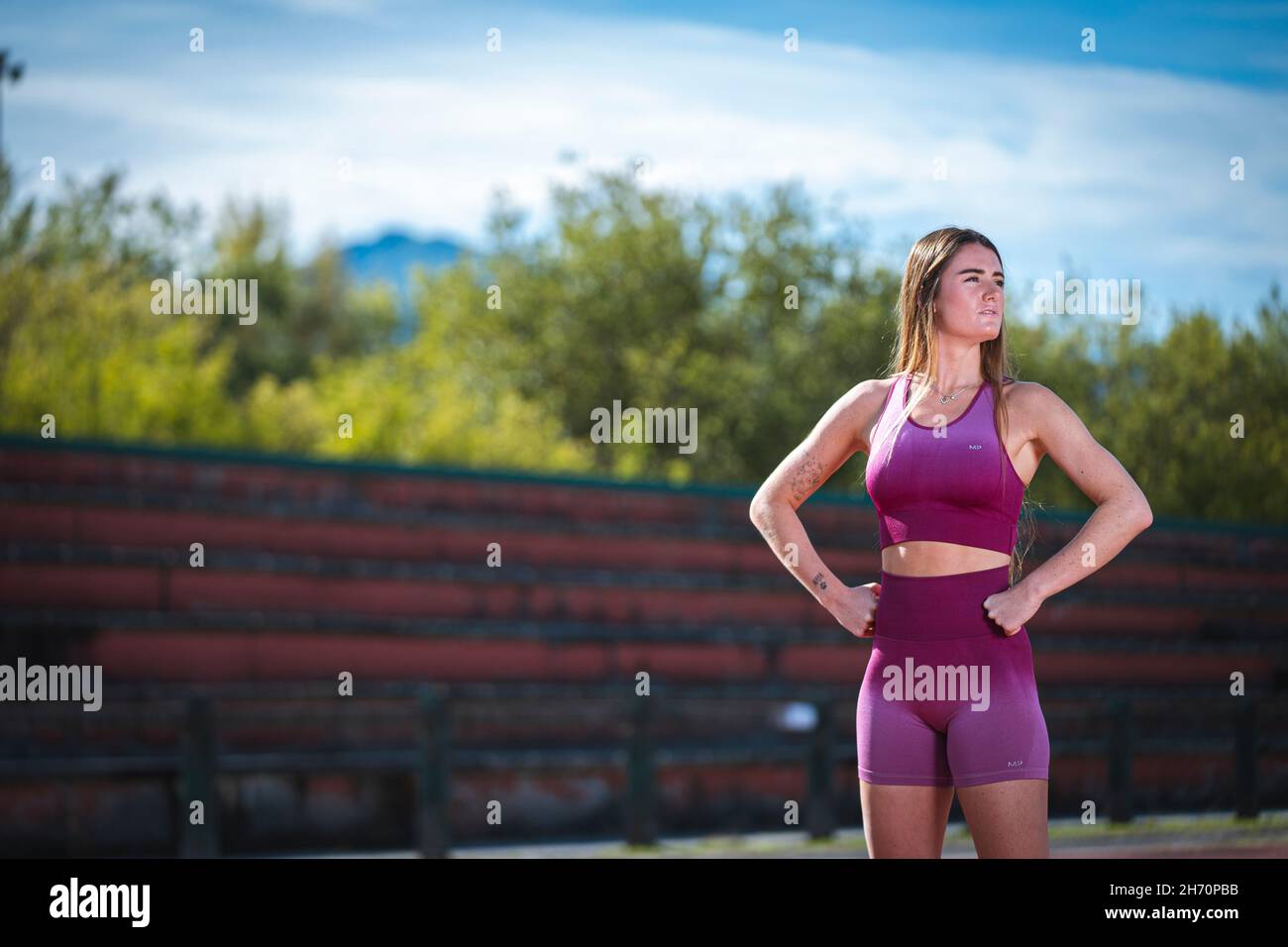 Athlete model girl posing on the running track Stock Photo - Alamy