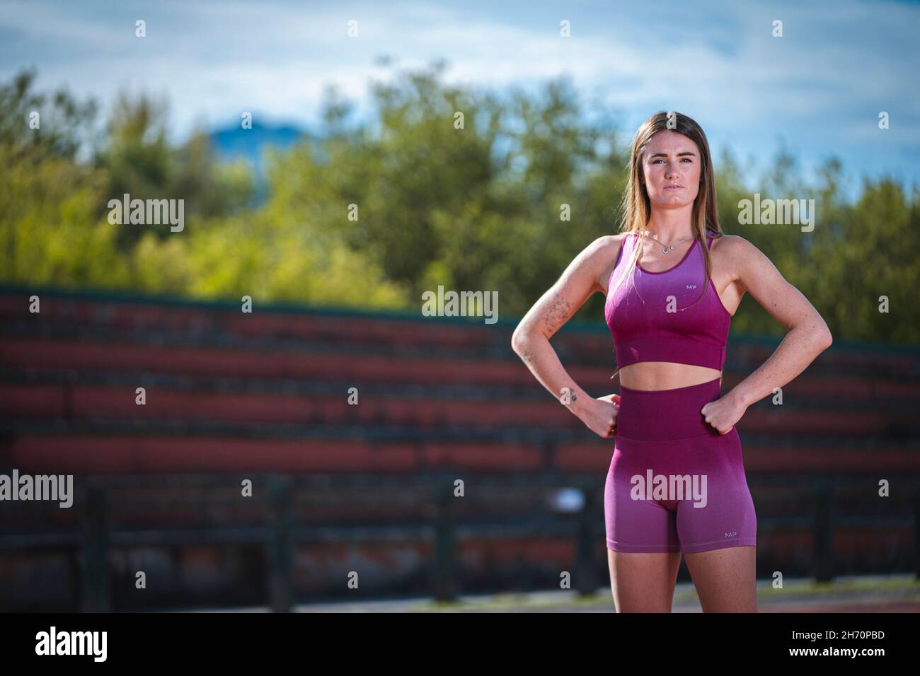 Athlete model girl posing on the running track Stock Photo - Alamy