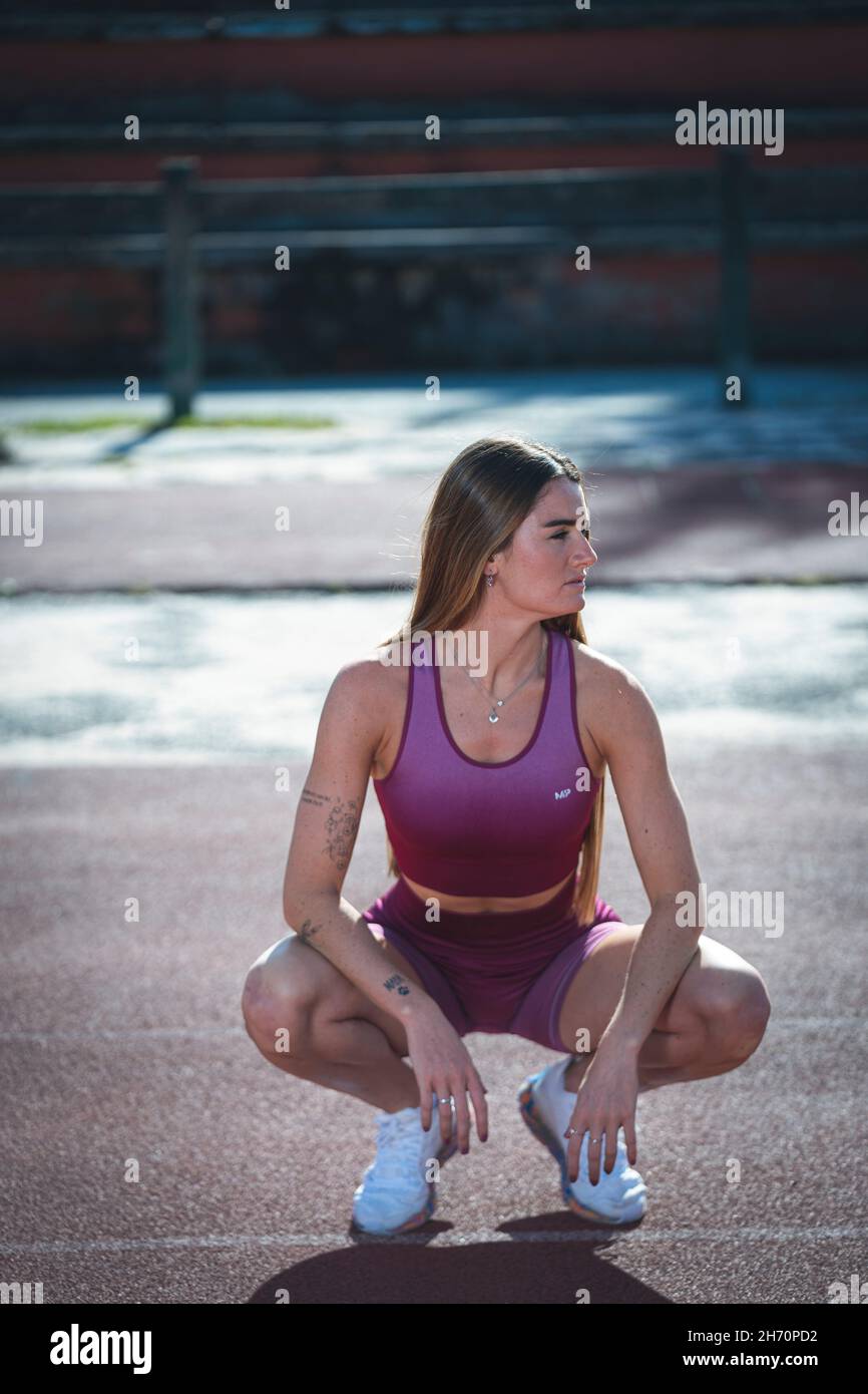 Athlete model girl posing on the running track Stock Photo - Alamy