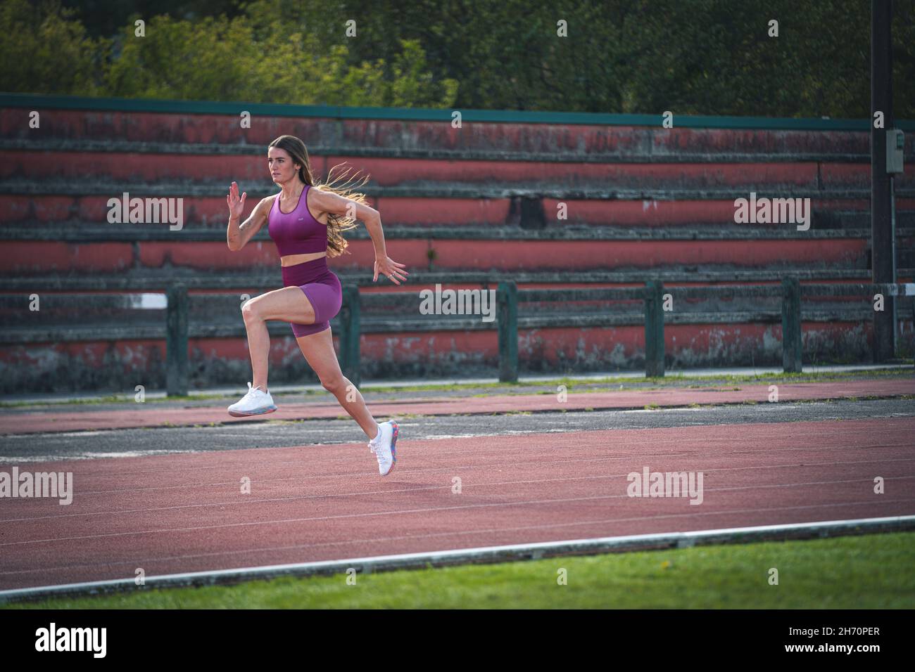 Girl model athlete running on the running track Stock Photo - Alamy