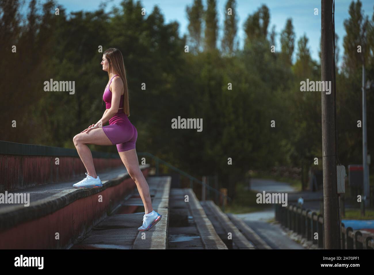 Athlete model girl posing on the running track Stock Photo - Alamy
