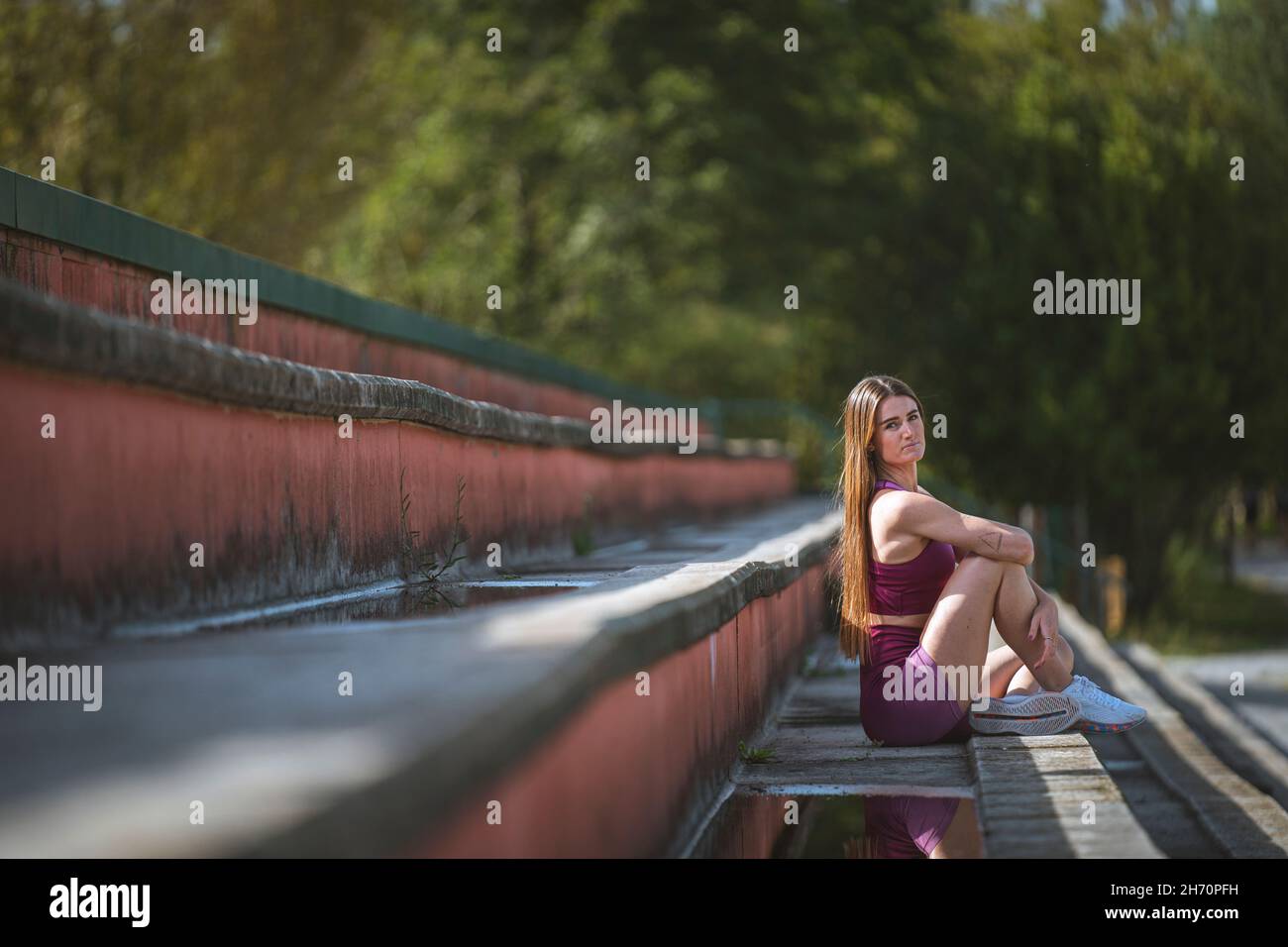 Athlete model girl posing on the running track Stock Photo - Alamy