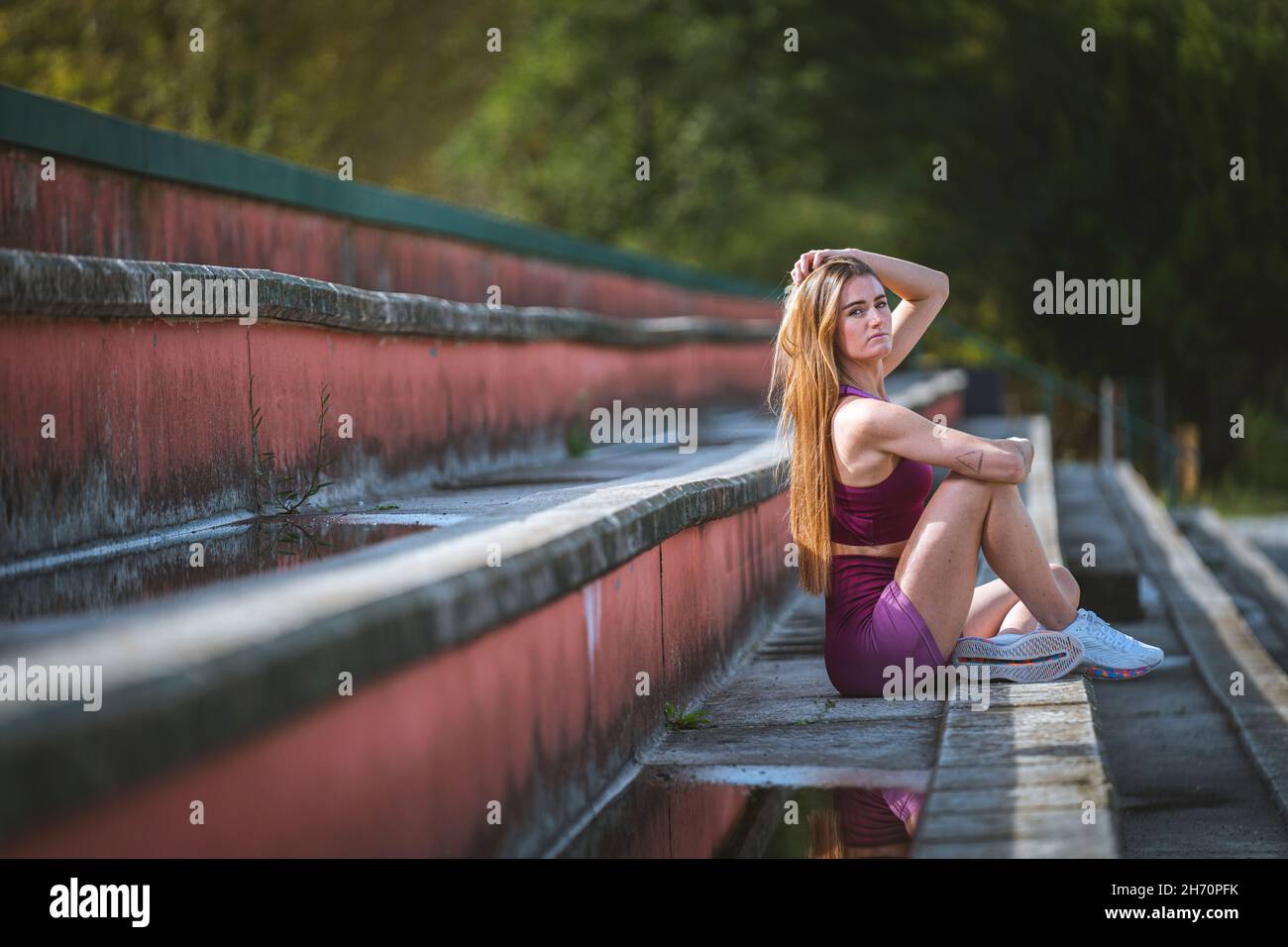 Athlete model girl posing on the running track Stock Photo - Alamy
