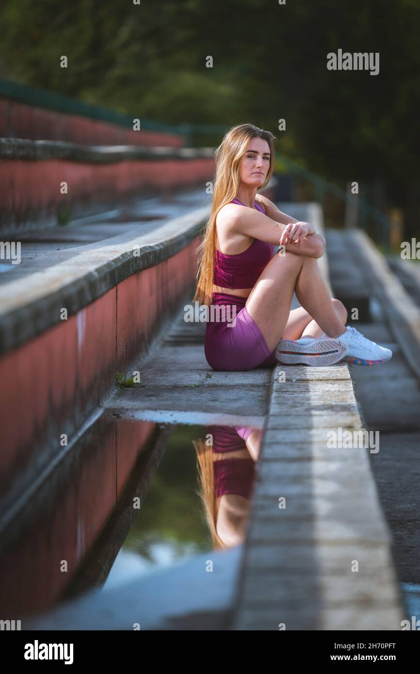 Athlete model girl posing on the running track Stock Photo - Alamy