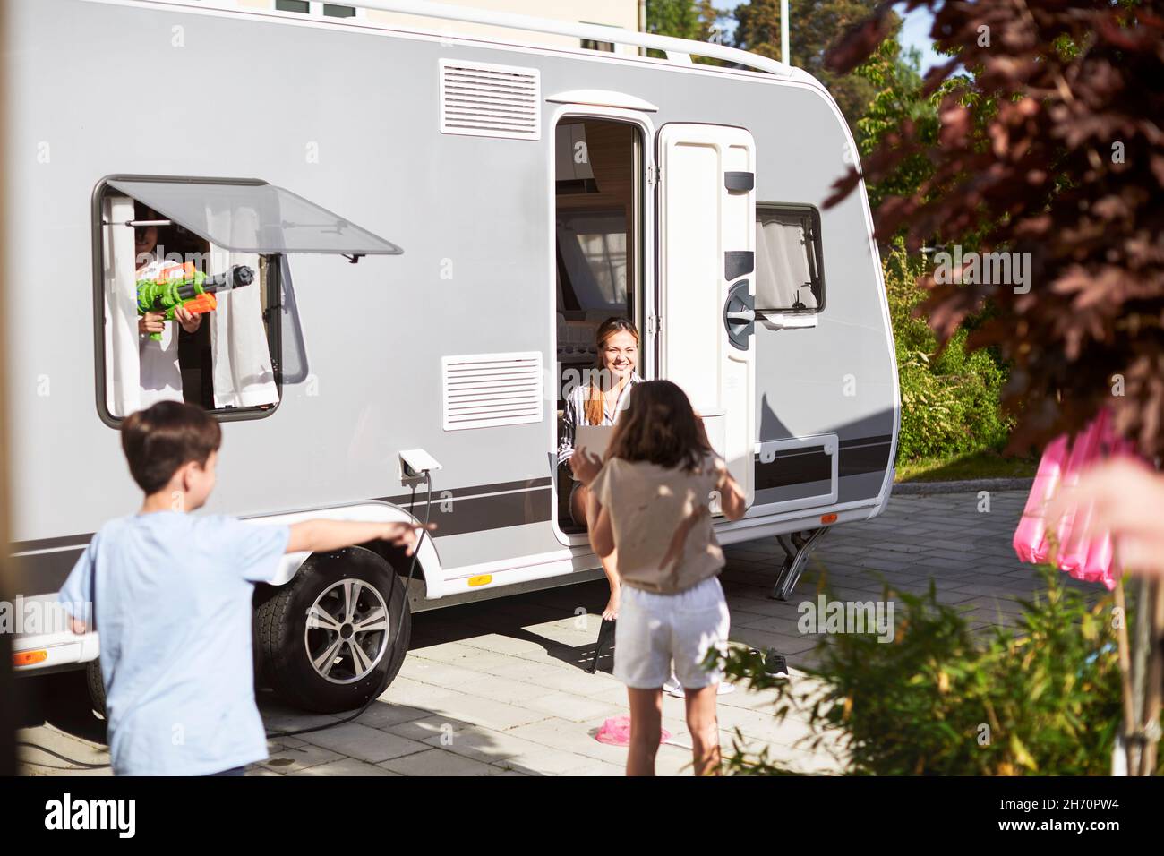 Children playing around caravan Stock Photo - Alamy