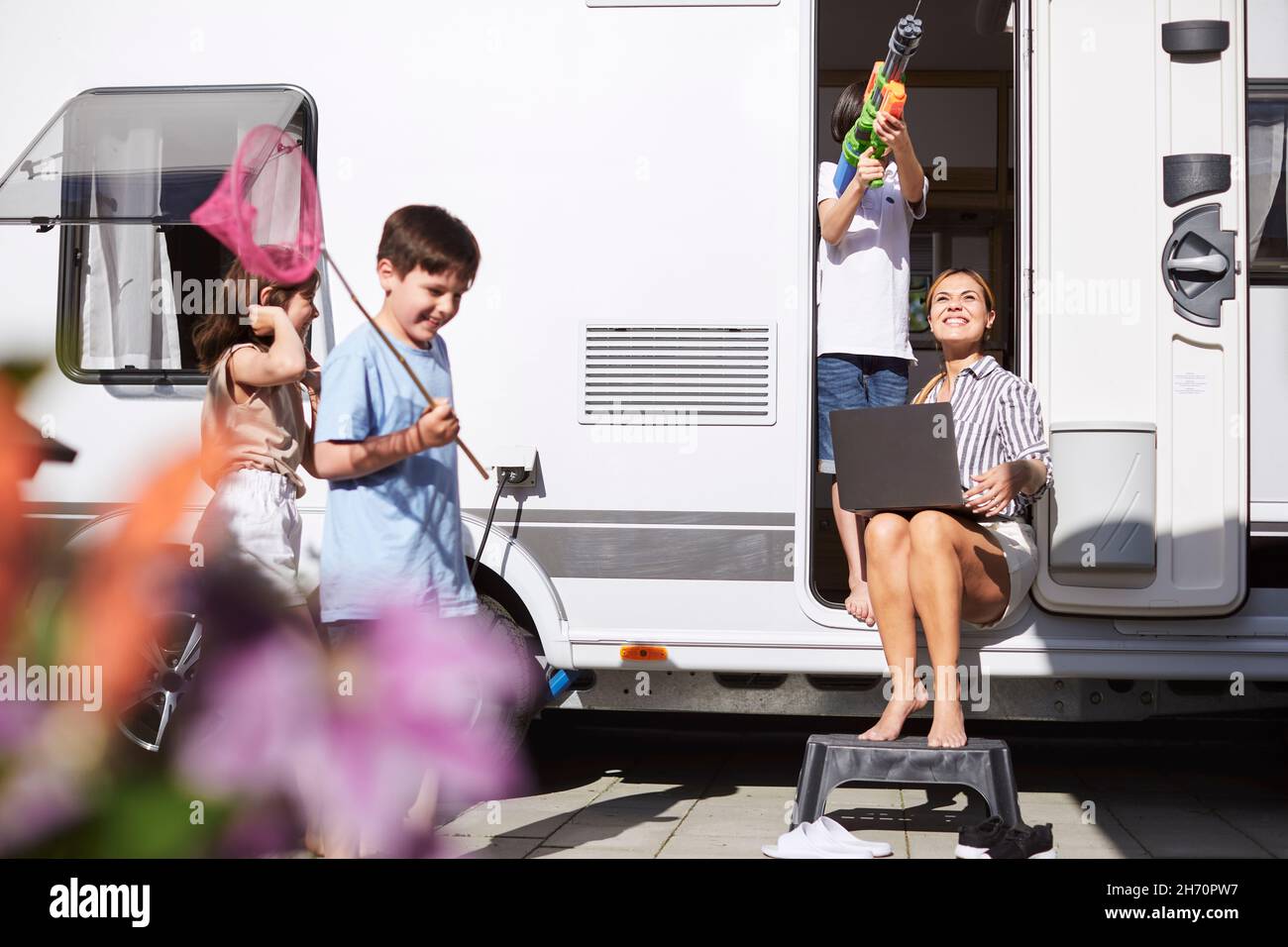 Children playing around caravan Stock Photo - Alamy