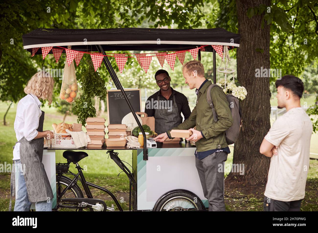 Clients buying food at food stall Stock Photo - Alamy