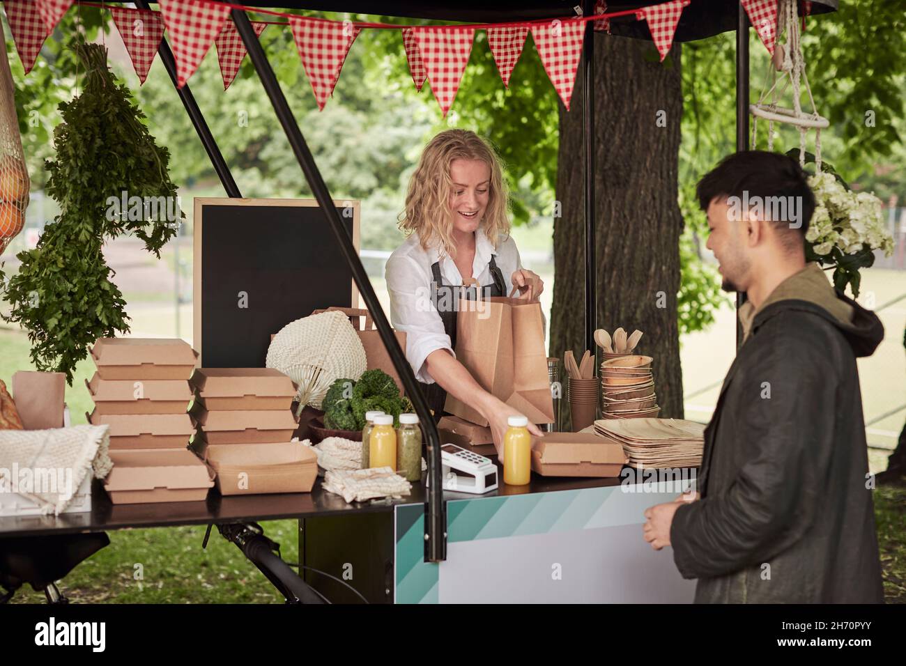 Clients buying food at food stall Stock Photo - Alamy