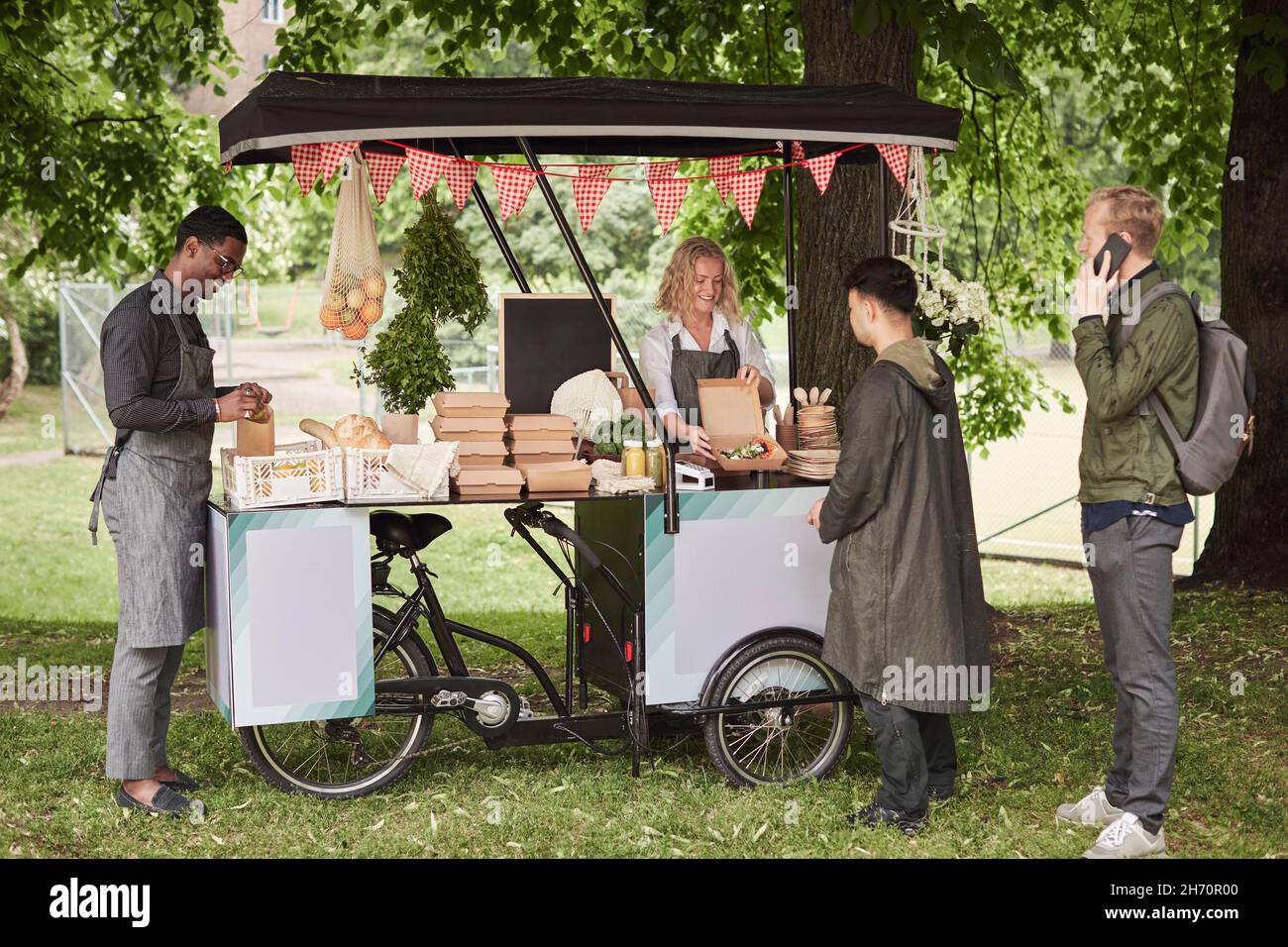 Clients buying food at food stall Stock Photo - Alamy