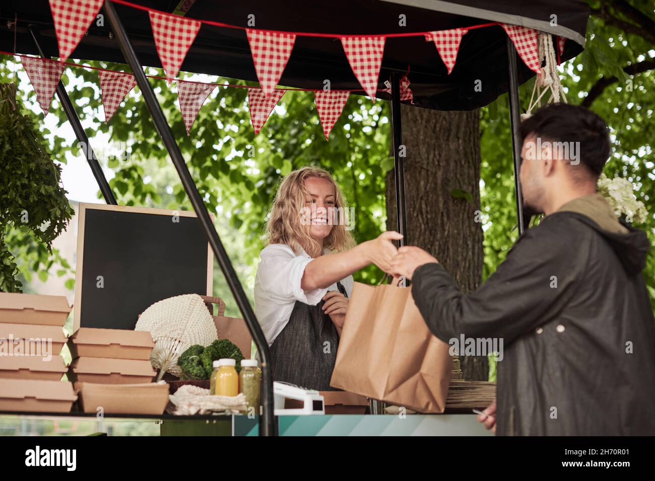 Clients buying food at food stall Stock Photo - Alamy