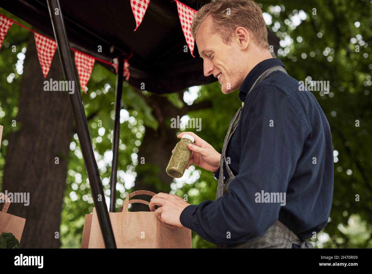 Man working at food stall Stock Photo - Alamy