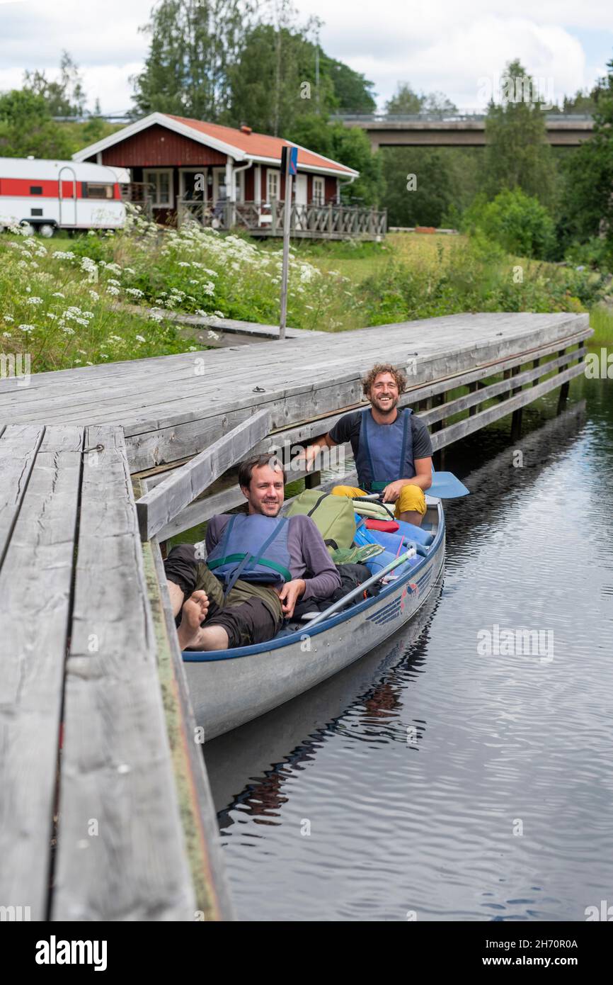 Smiling men in rowing boat Stock Photo - Alamy