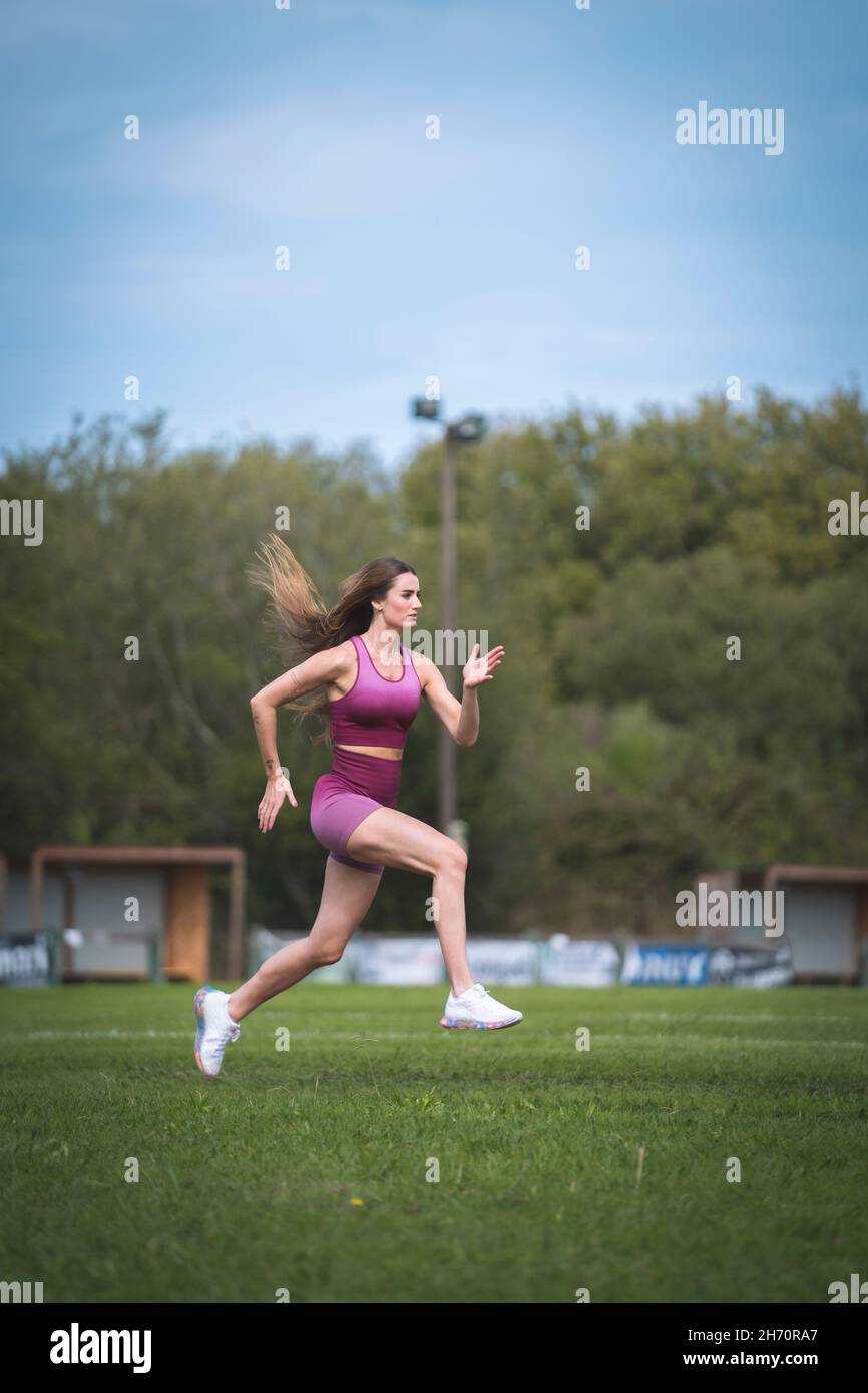 Girl model athlete running on the running track Stock Photo - Alamy