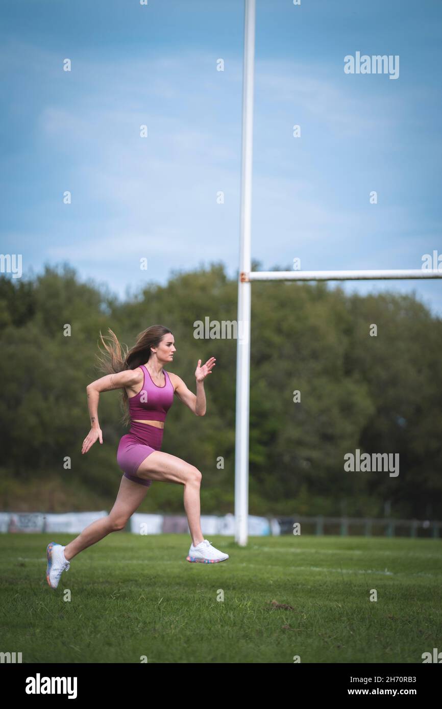 Girl model athlete running on the running track Stock Photo - Alamy